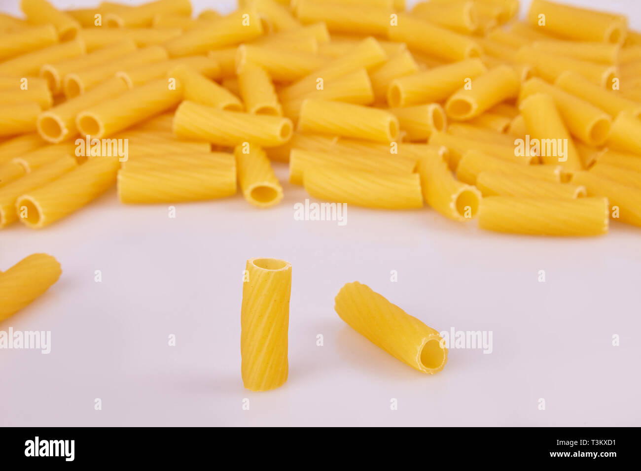Raw pasta background. Uncooked pasta tubules background. Food ...