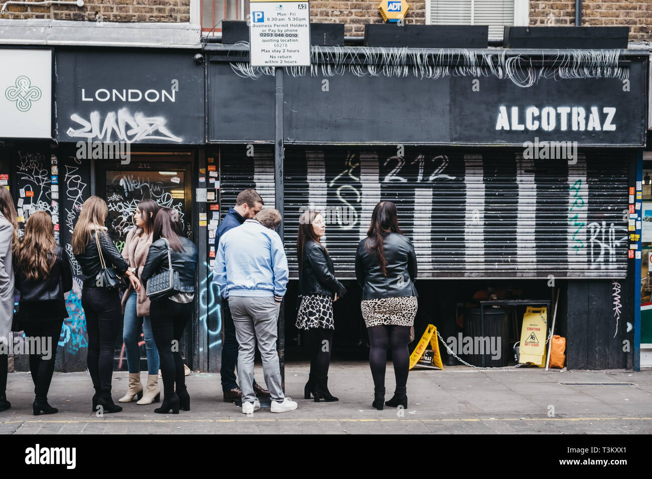 London, UK - April 6, 2019: People queuing outside Alcotraz, prison ...