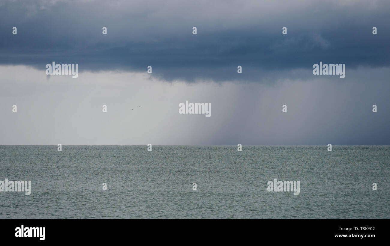Rain in distance over ocean hi-res stock photography and images - Alamy