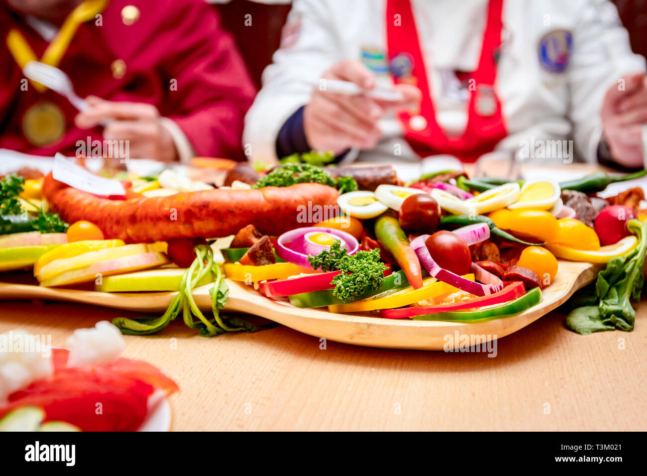 Decorated sausages with fresh vegetables are exposed on traditional ...