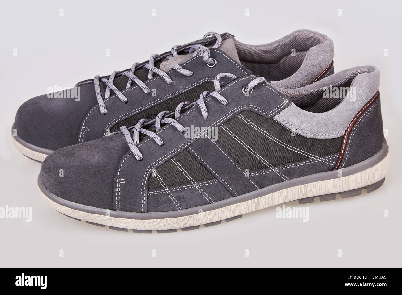 Pair of new modern grey stylish sneakers for men isolated on white ...