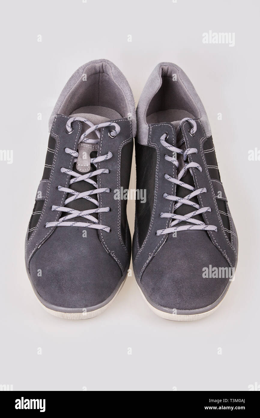 Pair of new modern grey stylish sneakers for men isolated on white ...