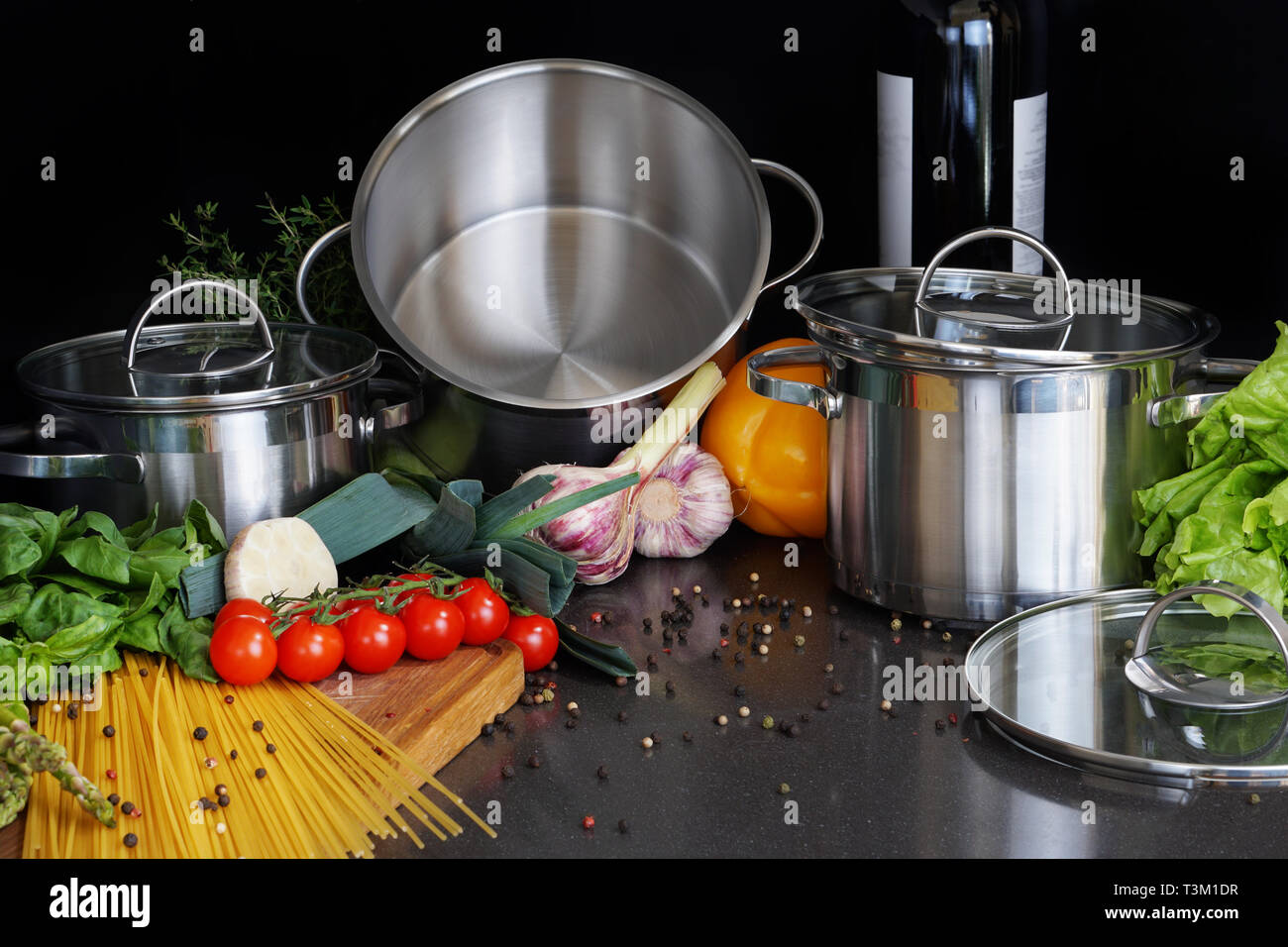 Metal casserole in the kitchen with natural ingredients for cooking ...