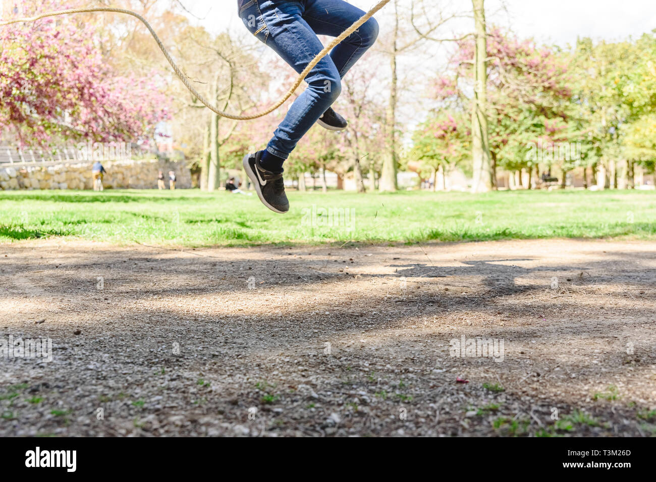 Girl playing jumping rope in a park in summer Stock Photo - Alamy