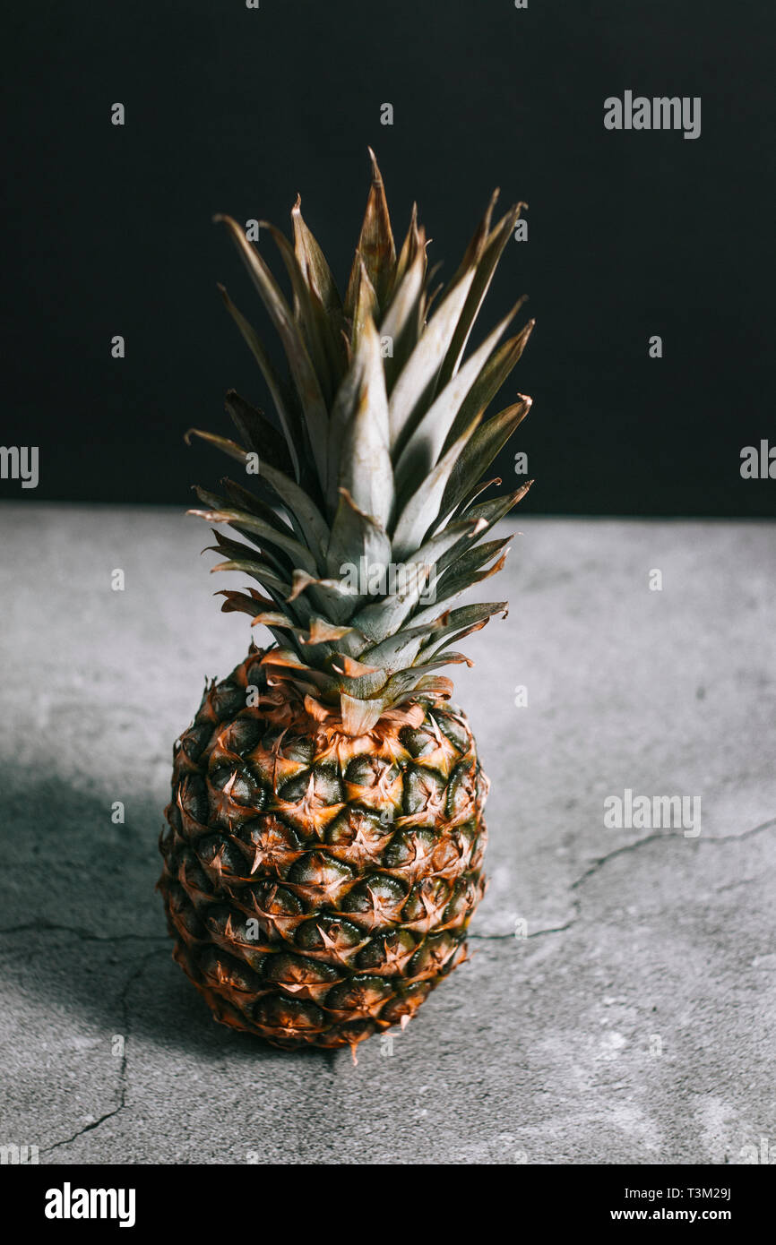 Beautiful pineapple in a studio on a stone surface Stock Photo - Alamy