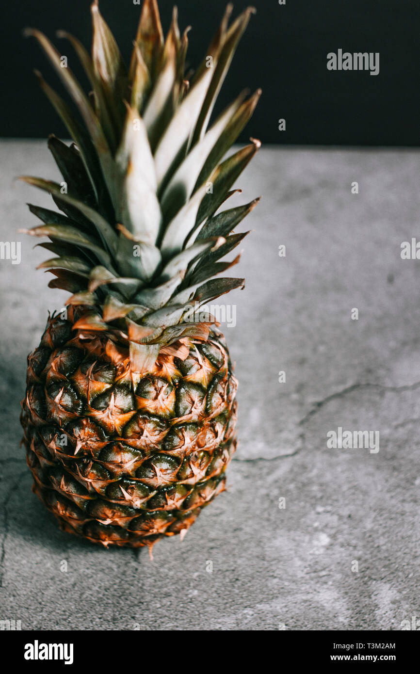 Beautiful pineapple in a studio on a stone surface Stock Photo - Alamy
