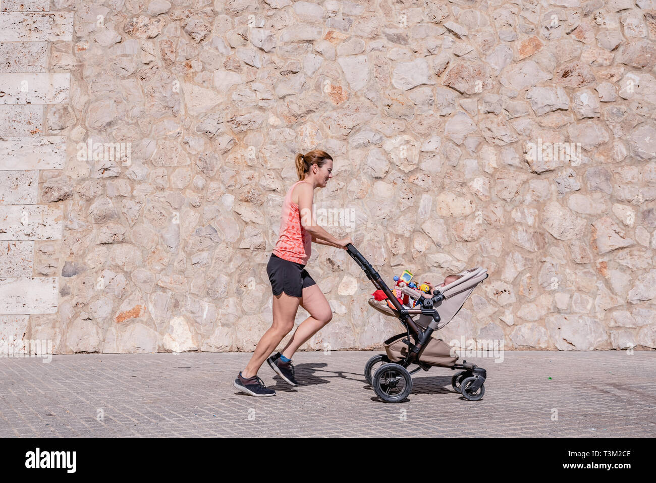 Woman, mother doing fitness pushing the baby stroller Stock Photo - Alamy