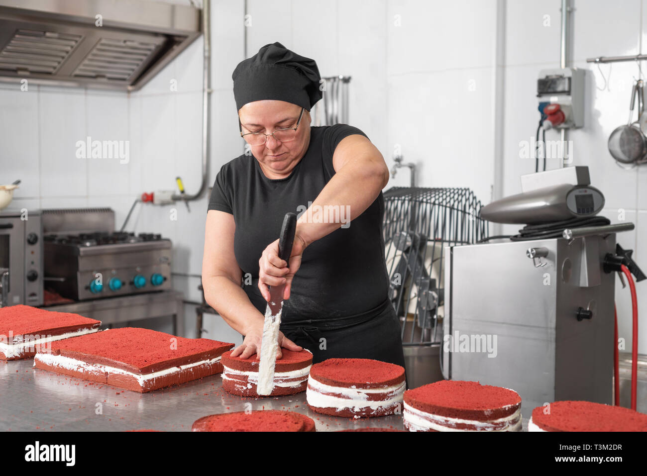 Woman pastry chef smiling and working happy, making cakes at the pastry ...