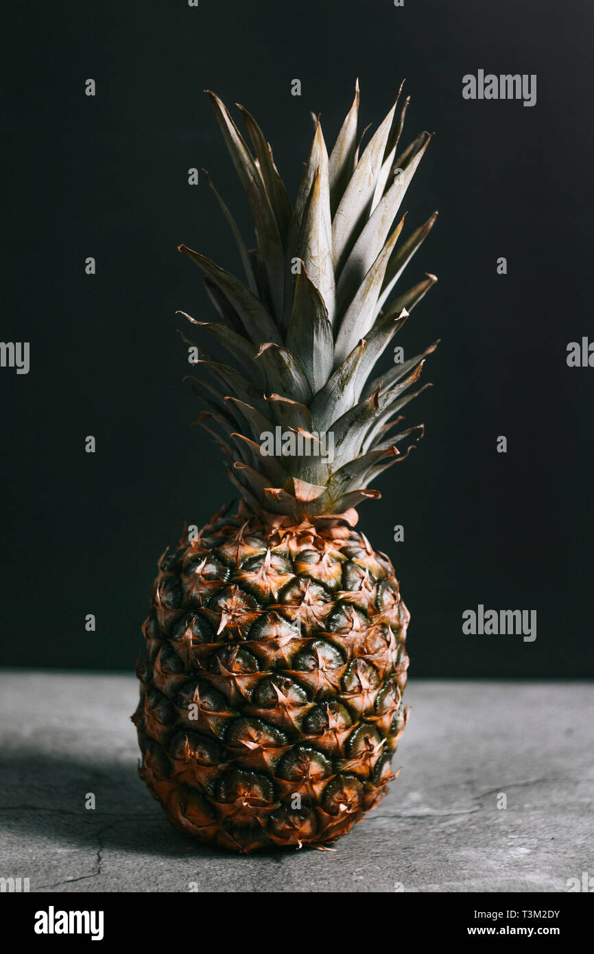 Beautiful pineapple in a studio on a stone surface Stock Photo - Alamy