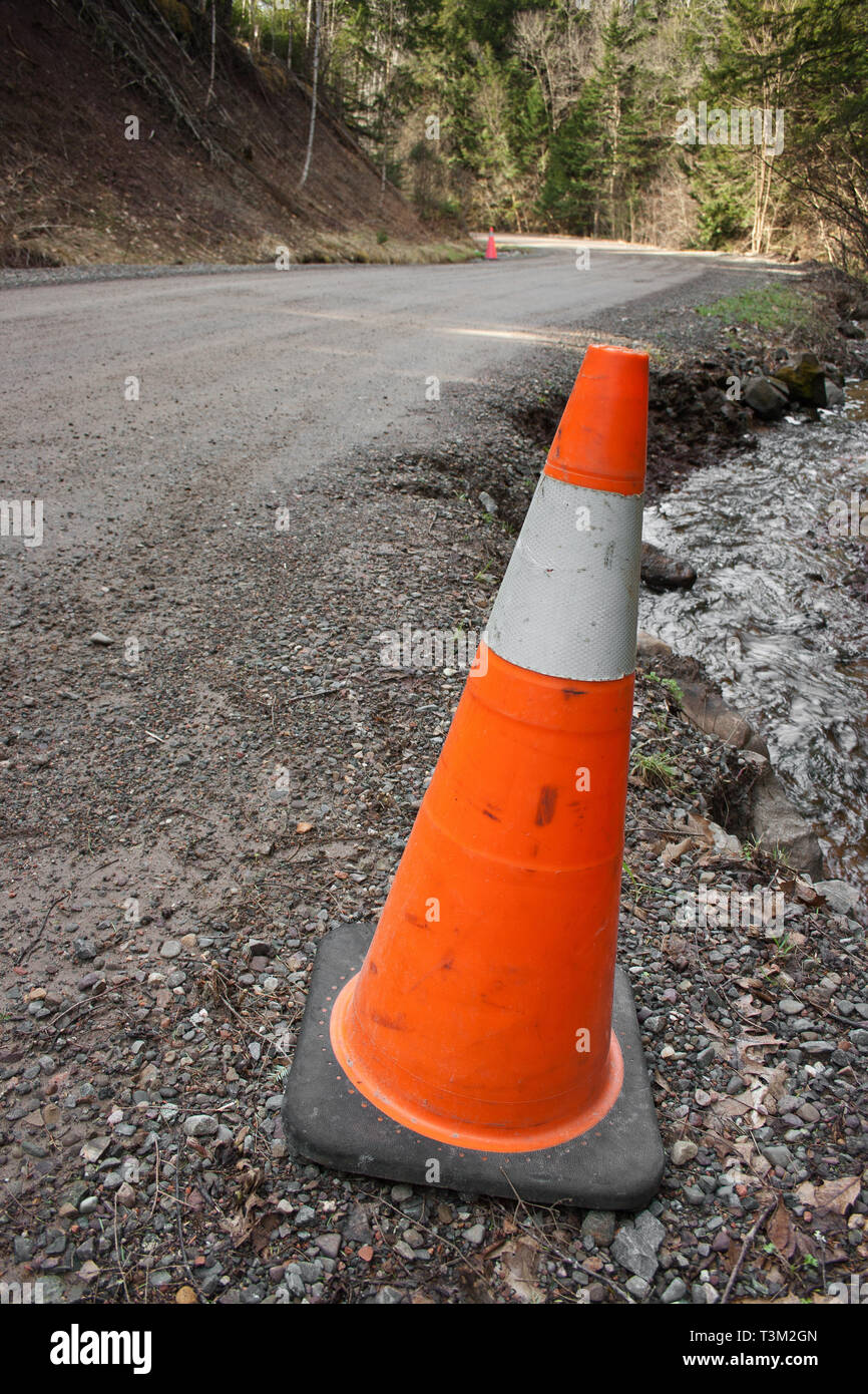Traffic safety cone on eroded rural gravel road Stock Photo - Alamy