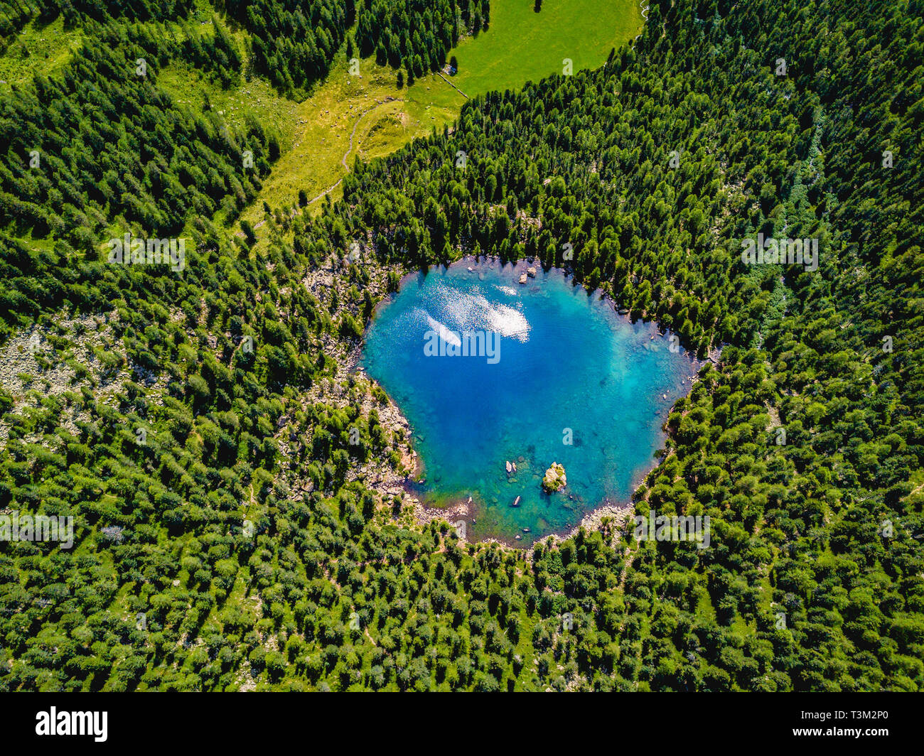 Aerial photo of a blue lake between alpine mountains Stock Photo - Alamy