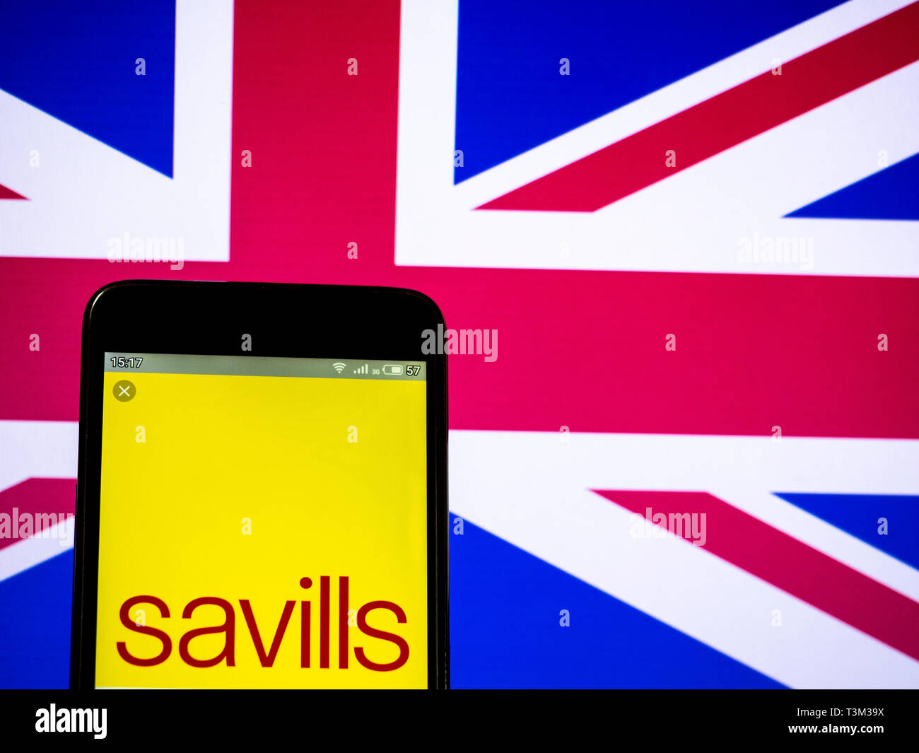In this photo illustration a logo Savills plc seen displayed on a smart ...