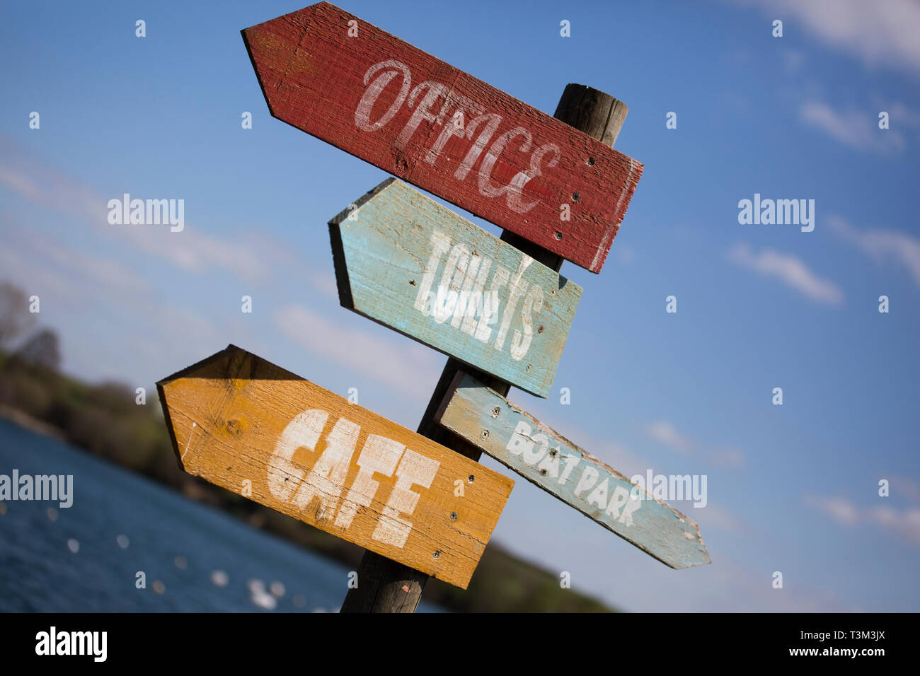 Rustic signpost with office, cafe, toilets and Boat park written on it ...