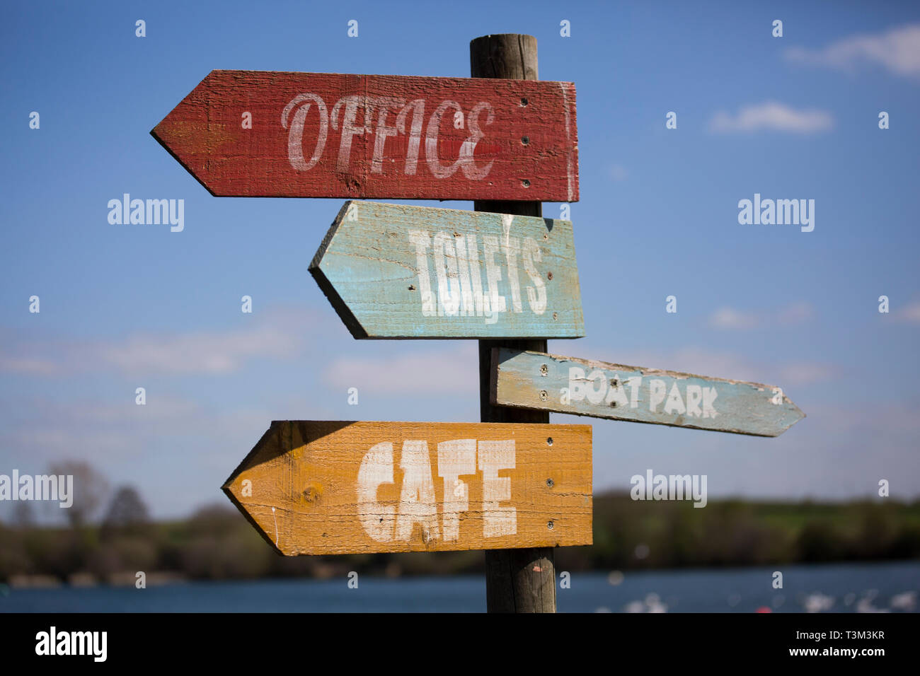 Rustic signpost with office, cafe, toilets and Boat park written on it ...
