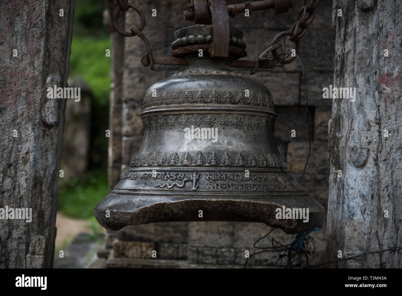 An old metal bell at a shrine on the hill above Pashupatinath temple ...