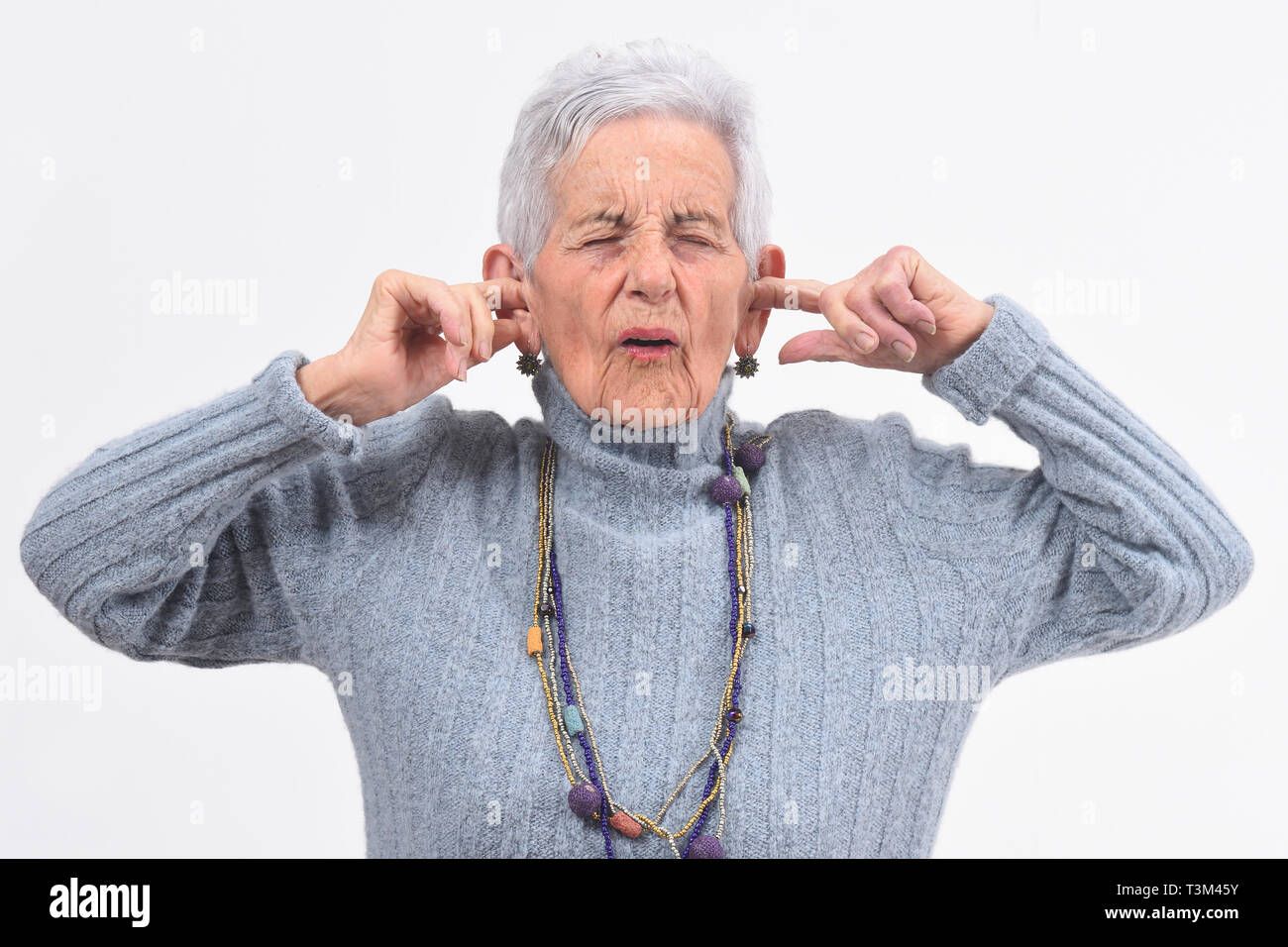 Old woman ears fingers hi-res stock photography and images - Alamy