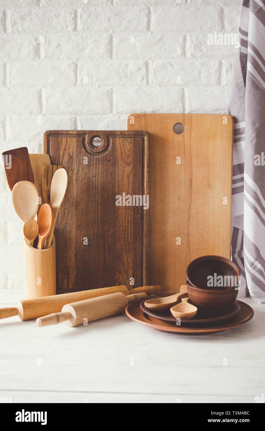 Simple rustic kitchenware: ceramic plates, wooden or bamboo cutlery ...