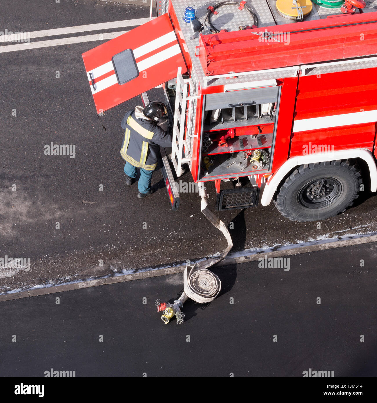 Red fire truck arrived on an emergency call. High angle view. Square ...