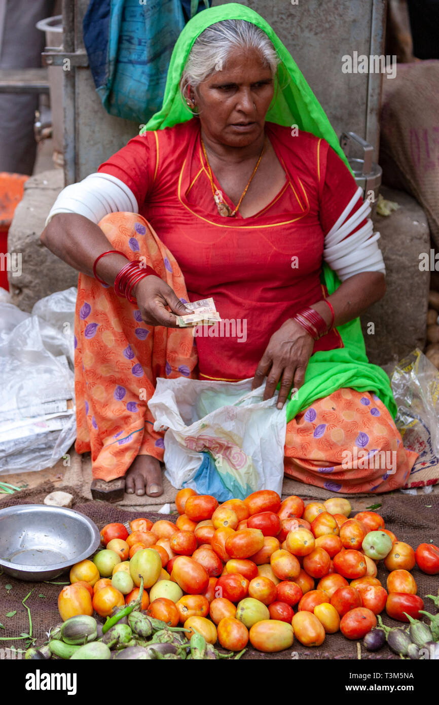 Woman selling tomatoes in the vegetable market i hi-res stock ...