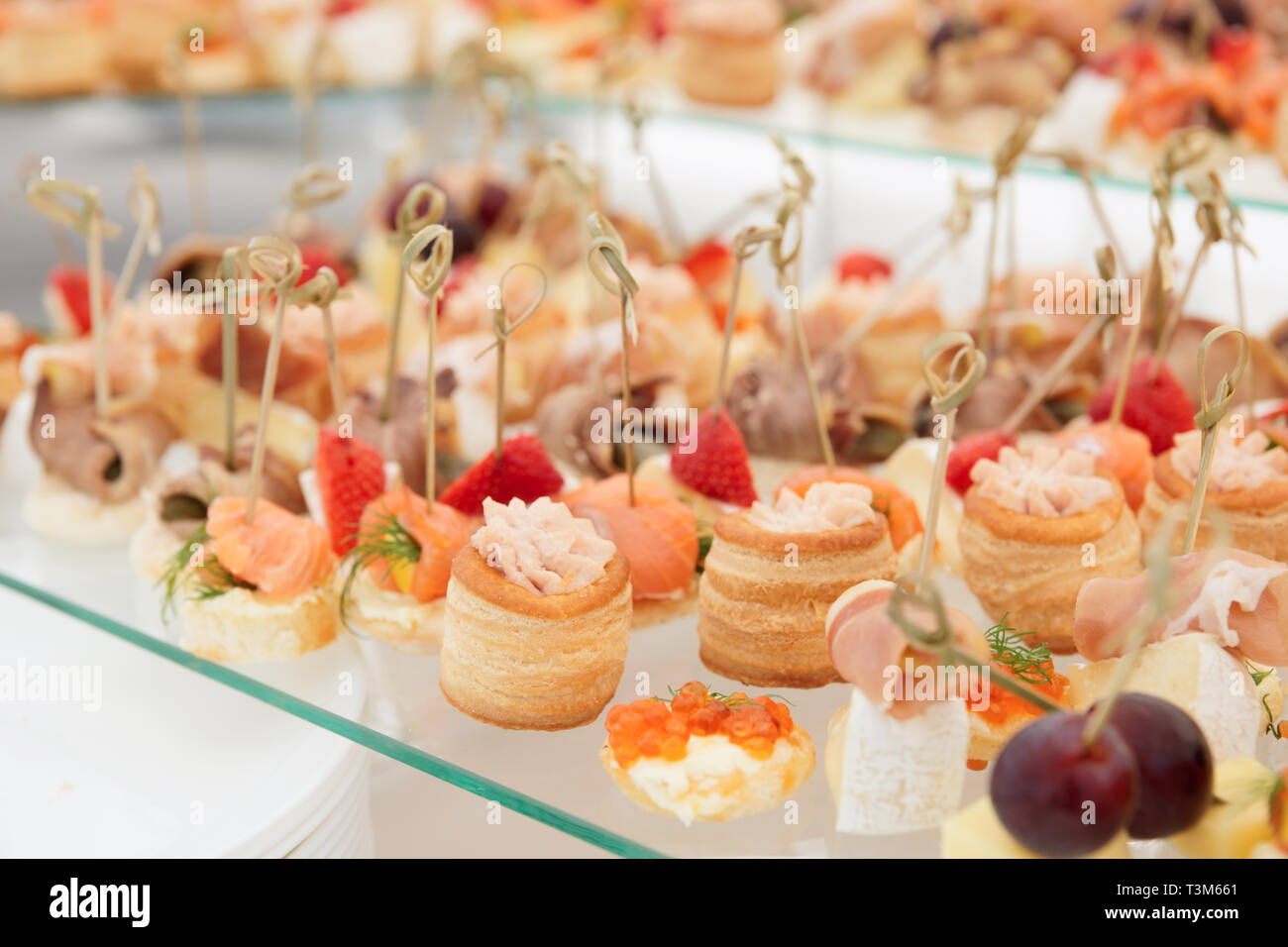 Various meat, fish and cheese banquet snacks on platter Stock Photo - Alamy