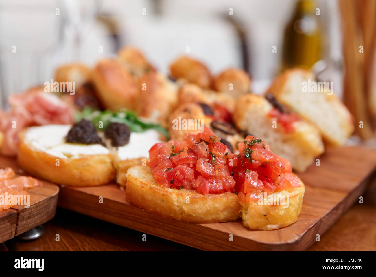 Italian appetizers on wooden plank, close-up Stock Photo - Alamy