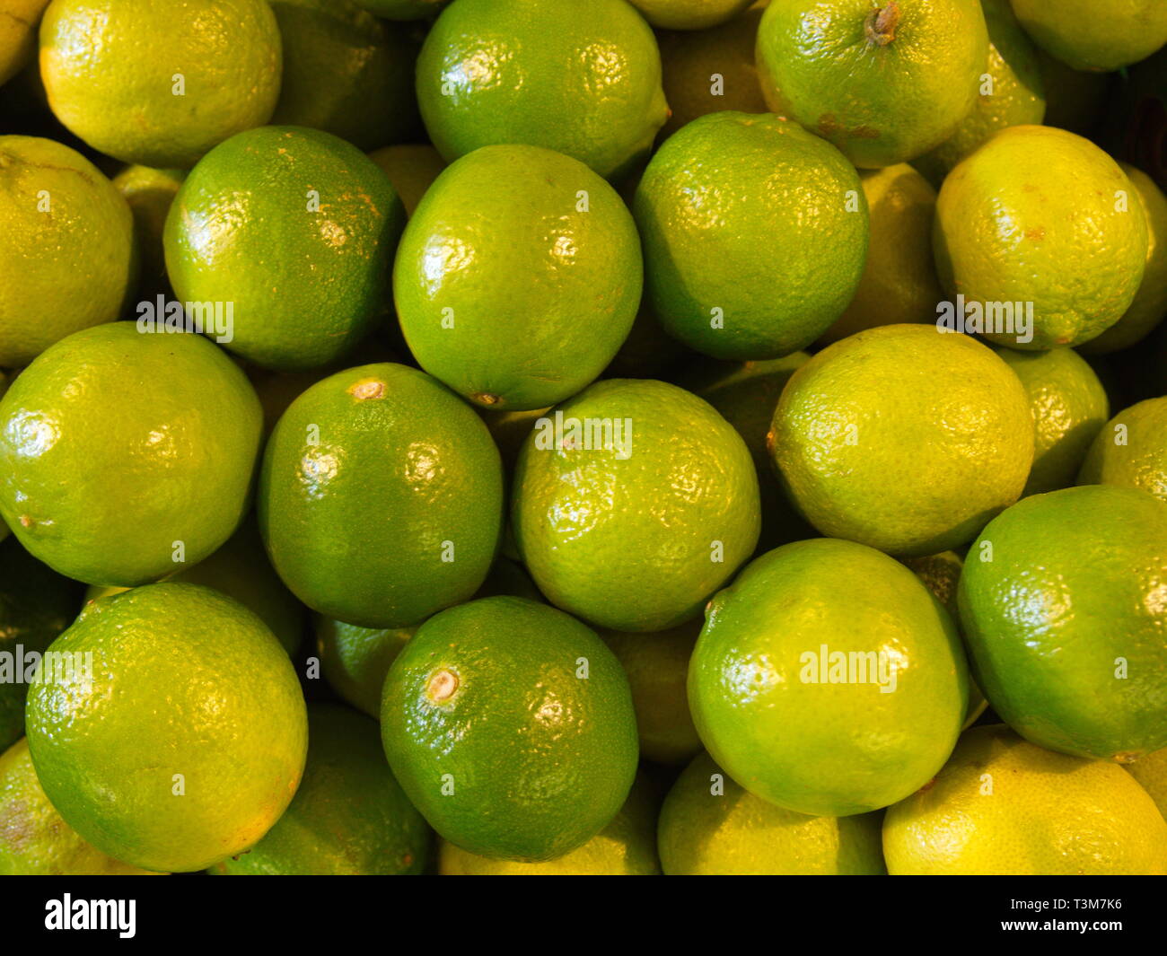 green lime close - up fruit background. stack of lemon Stock Photo - Alamy
