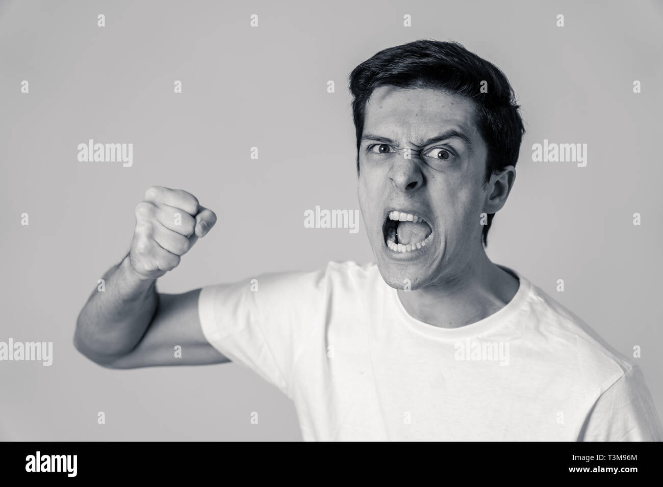 Black and white close up of young caucasian male with an angry face ...