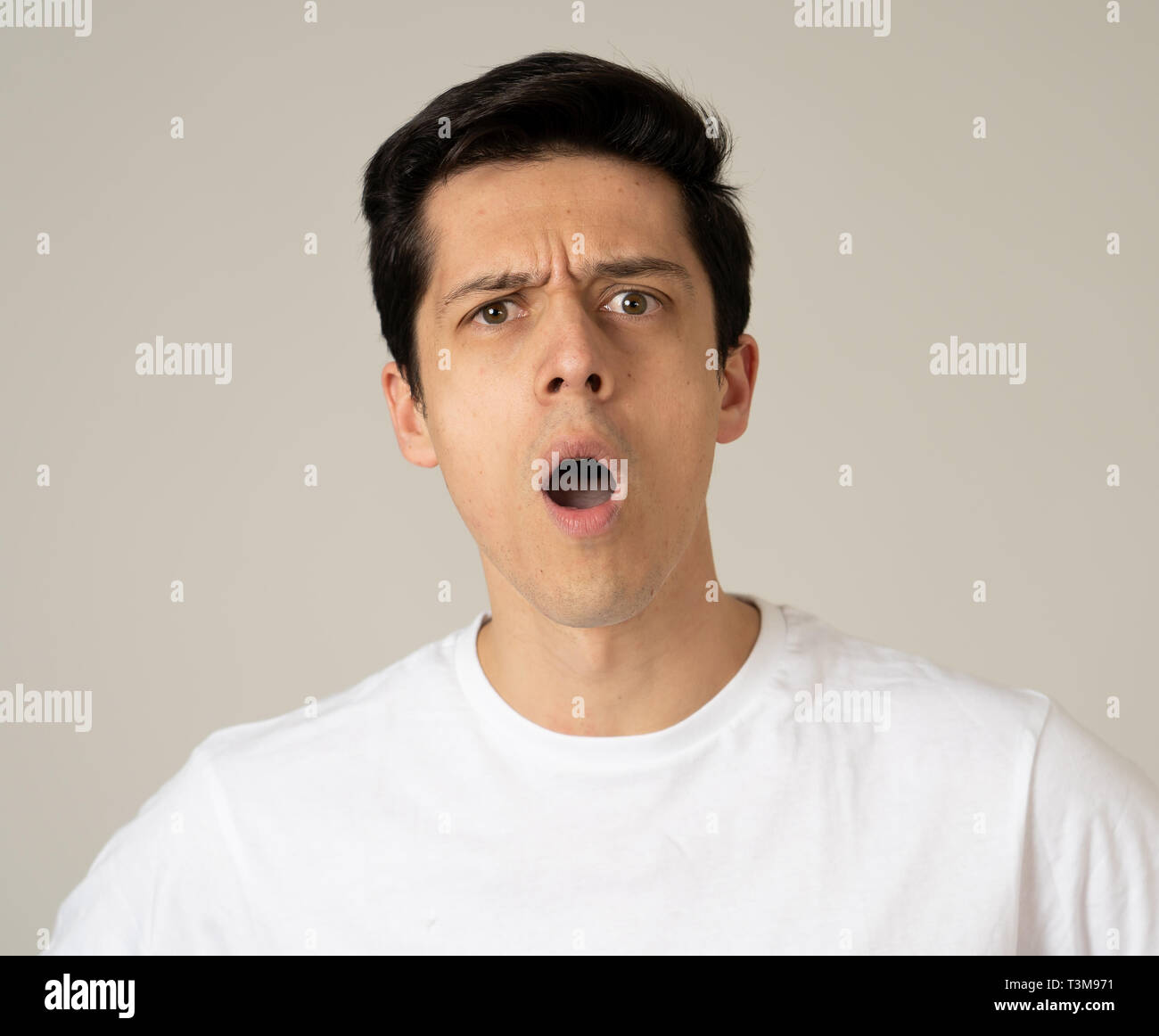 Close up portrait of a handsome caucasian young man with a surprised ...