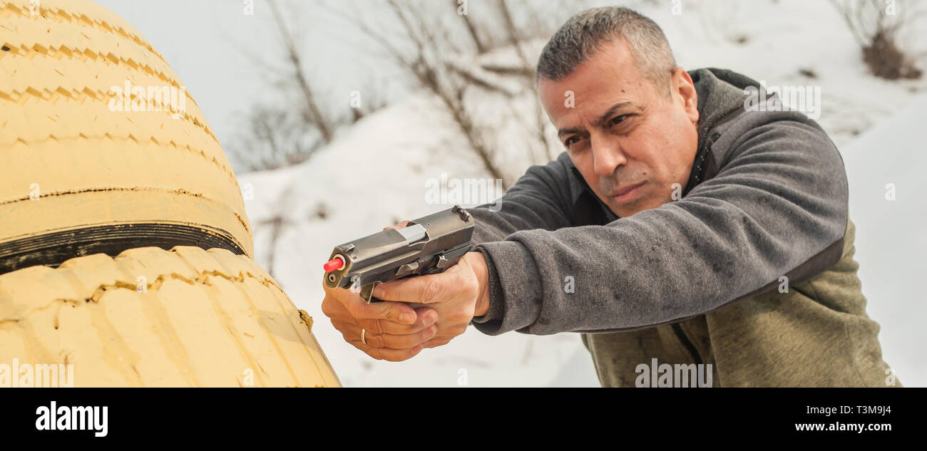 Man holding gun from behind hi-res stock photography and images - Alamy