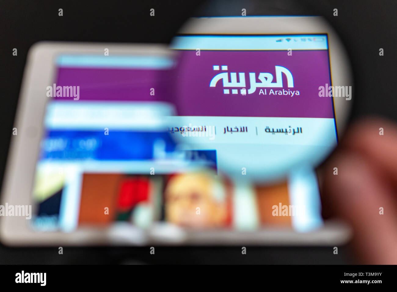 Al Arabiya News Media channel logo visible through a magnifying glass ...