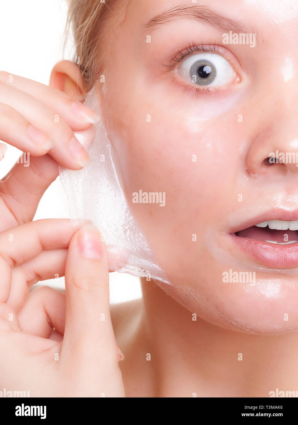 Part of female face. Surprised girl shocked young woman in facial peel ...
