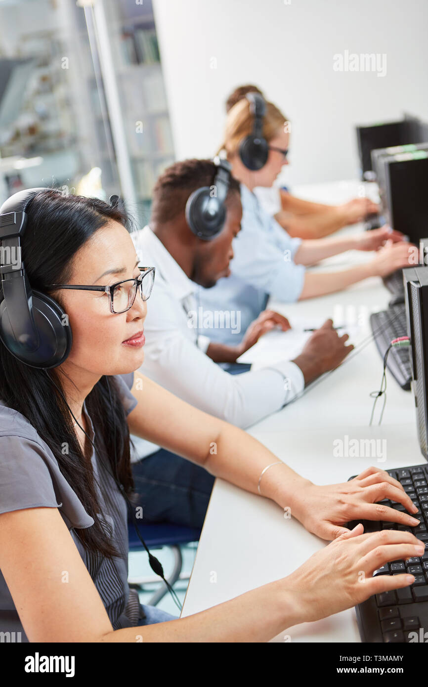 Business people in coworking office work side by side at computer ...