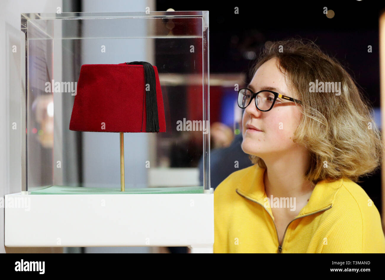A visitor looks at an original fez worn by Tommy Cooper during a press ...