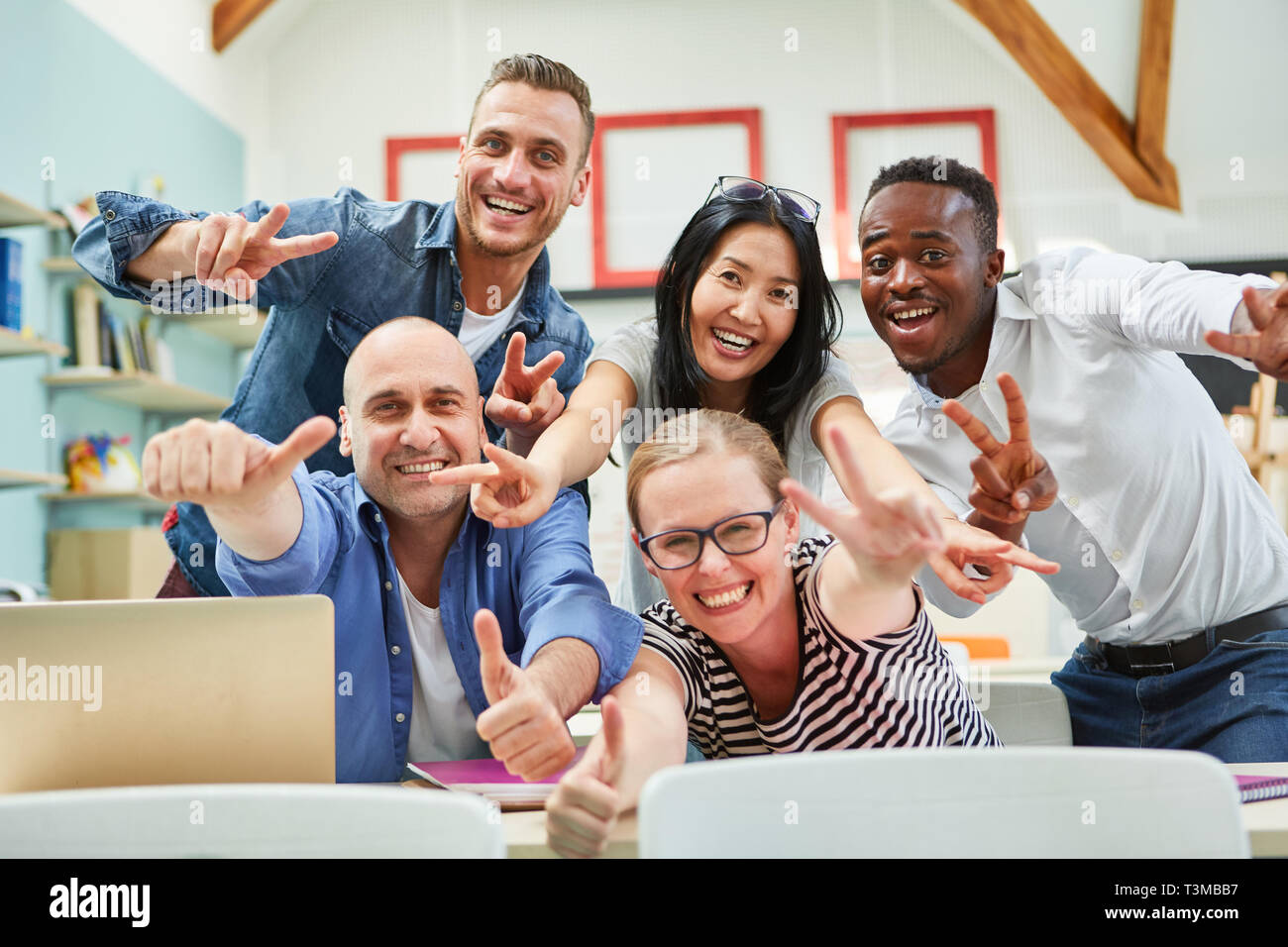Successful business start-up team with thumbs up is happy Stock Photo ...