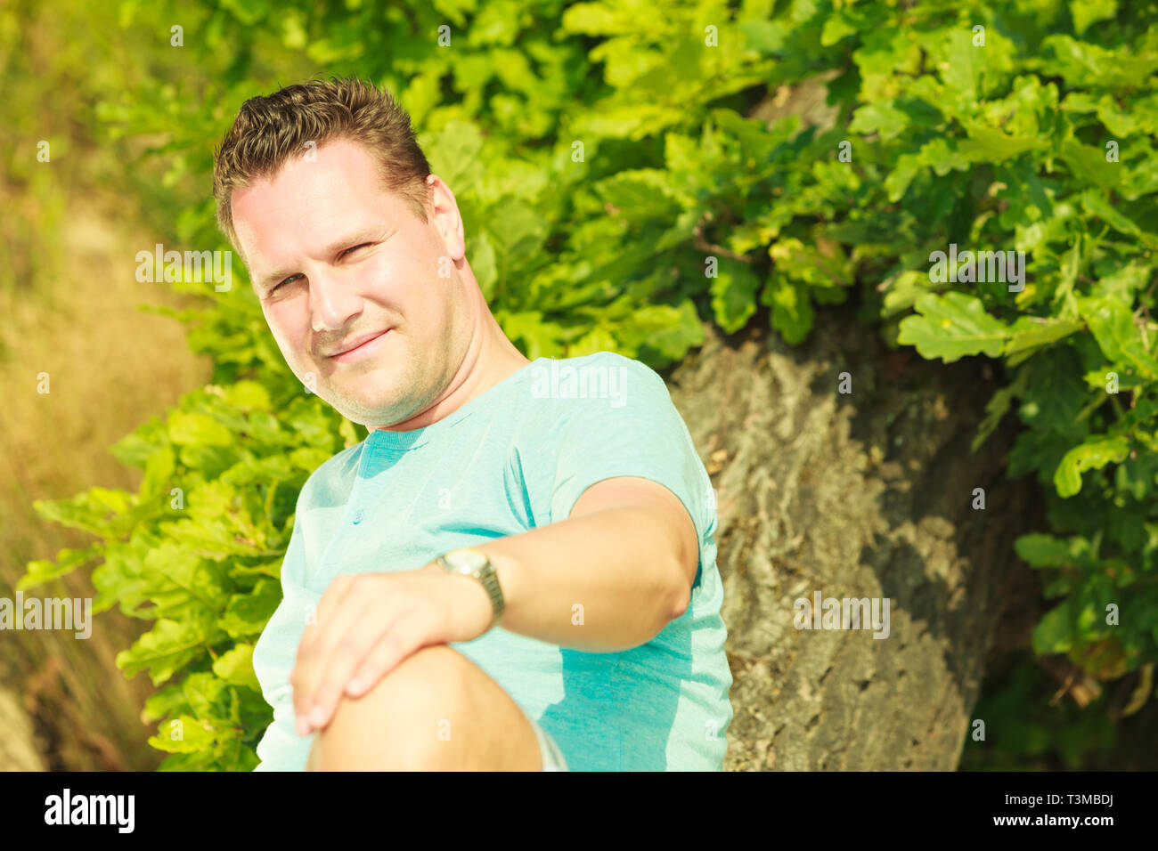 Outdoor nature relaxation concept. Handsome man spending his free time ...
