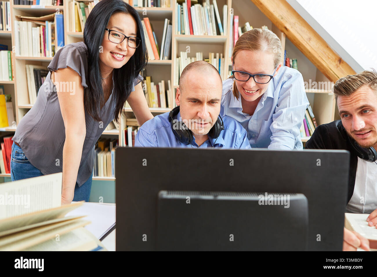 Creative start-up team works together on the PC as a software developer ...