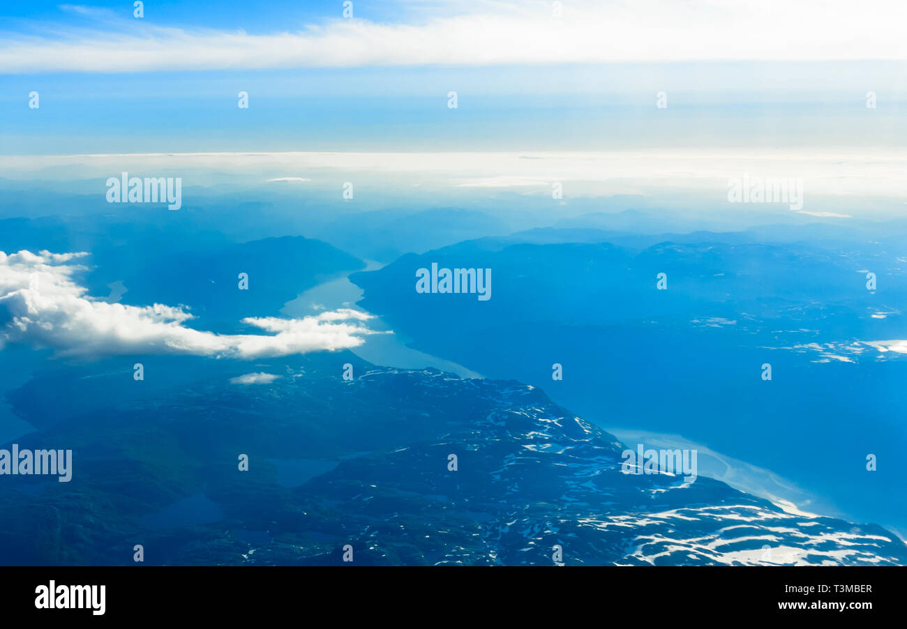 Birds eye. View from window of plane airplane flying over fjords Norway ...
