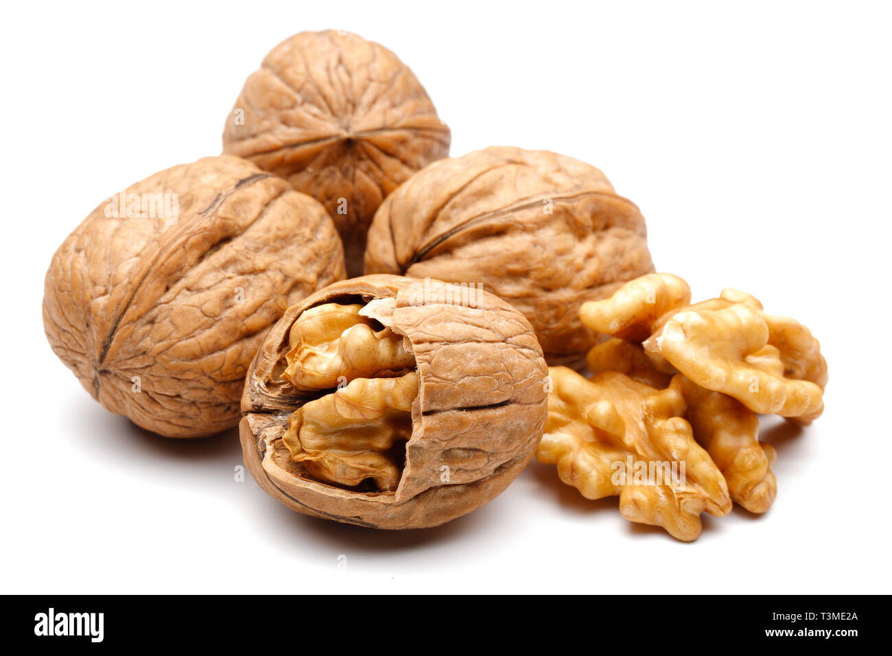 Whole and cracked walnuts isolated on white background Stock Photo - Alamy