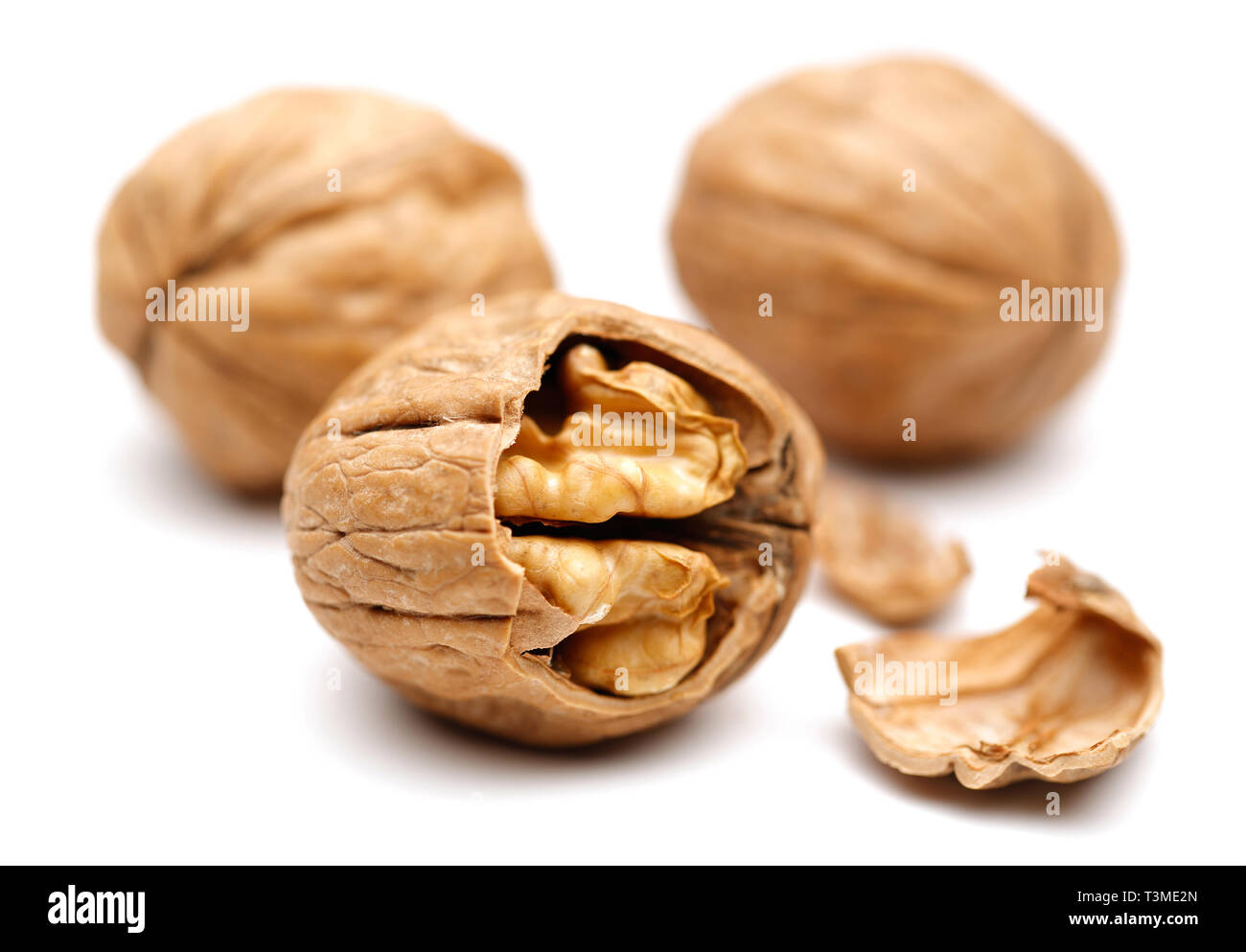 Whole and cracked walnuts isolated on white background Stock Photo - Alamy