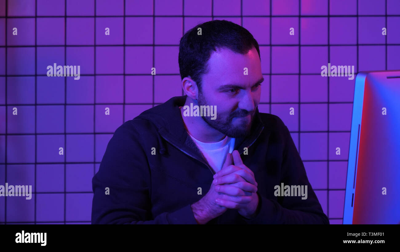 Hacker with evil look programing Stock Photo - Alamy