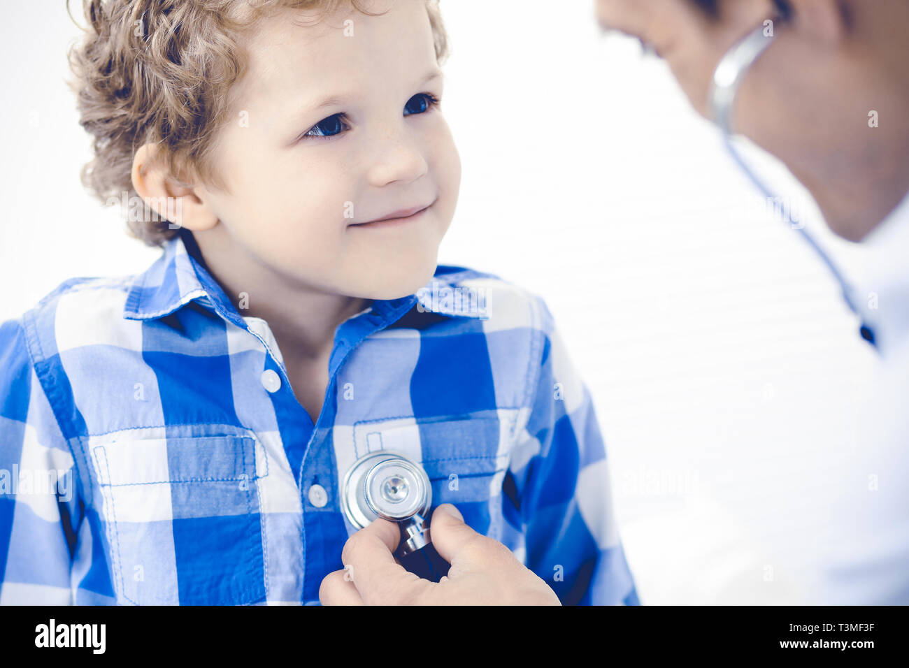 Doctor and patient child. Physician examining little boy. Regular ...