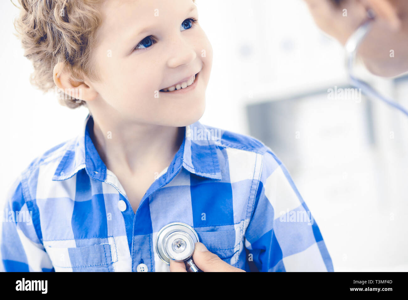 Doctor and patient child. Physician examining little boy. Regular ...