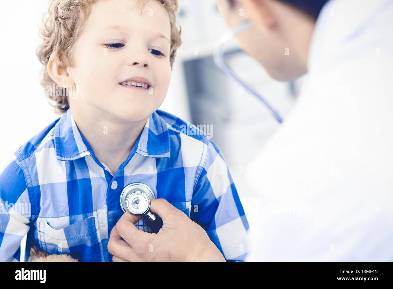 Doctor and patient child. Physician examining little boy. Regular ...