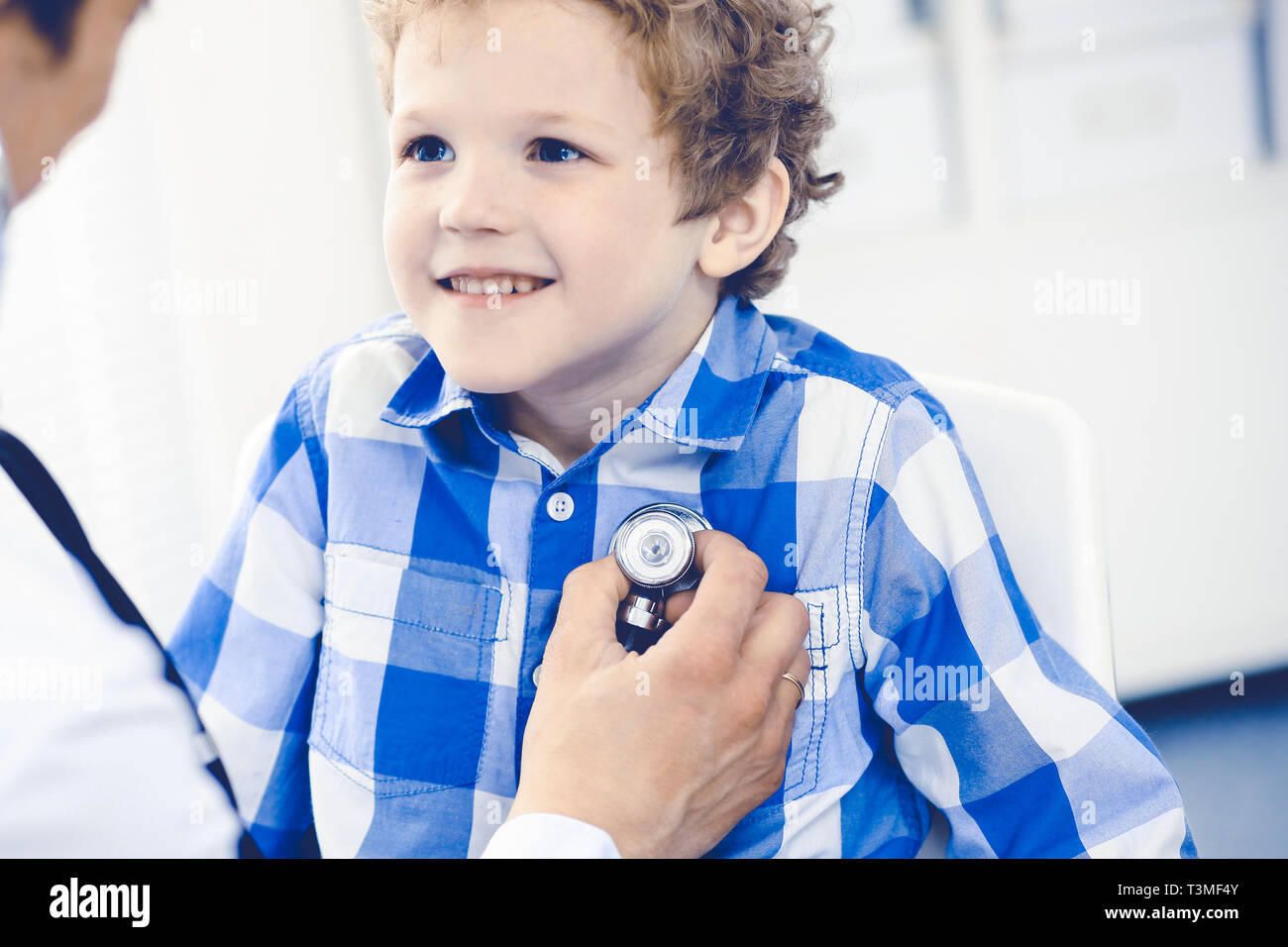 Doctor and patient child. Physician examining little boy. Regular ...
