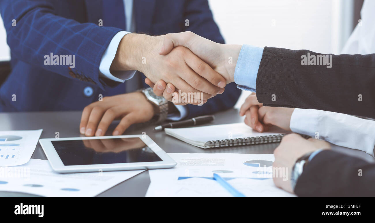 Business people shaking hands, finishing up a papers signing. Meeting ...