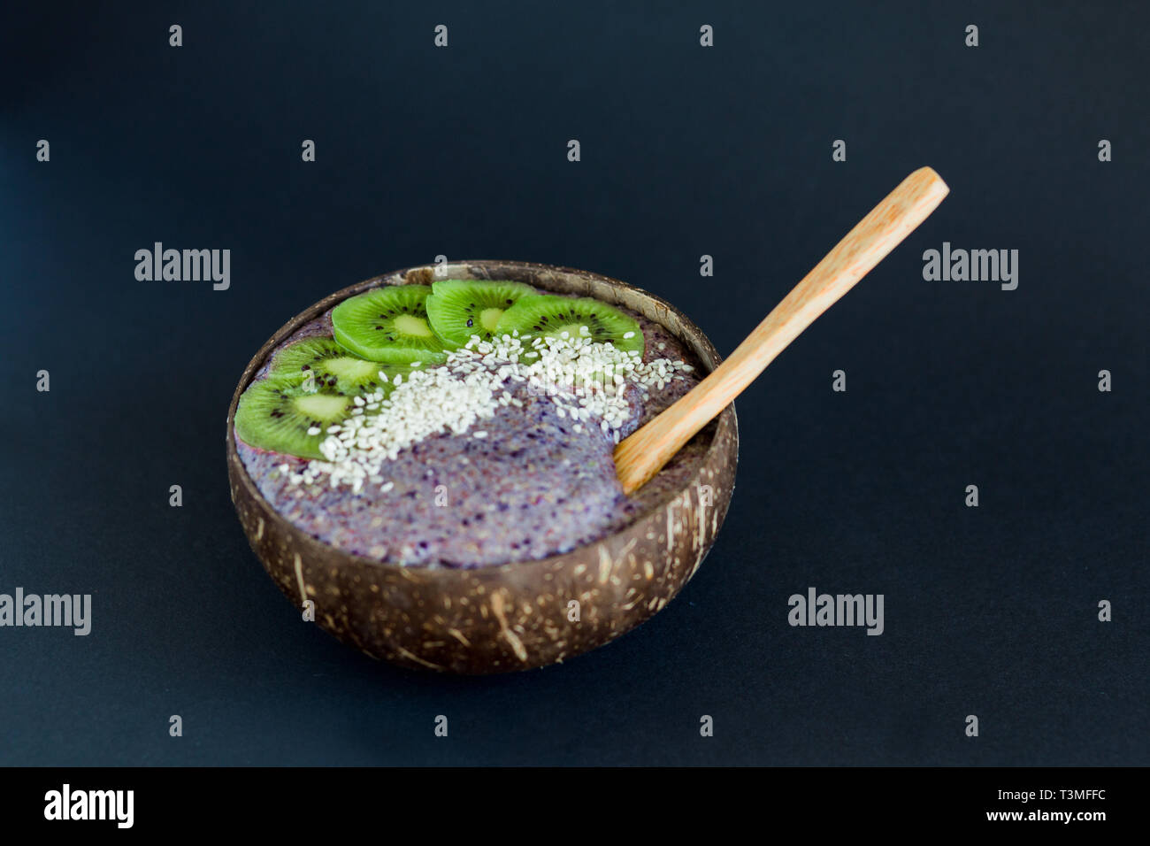Healthy smoothie with fruits, plate made from coconut shell and wood ...