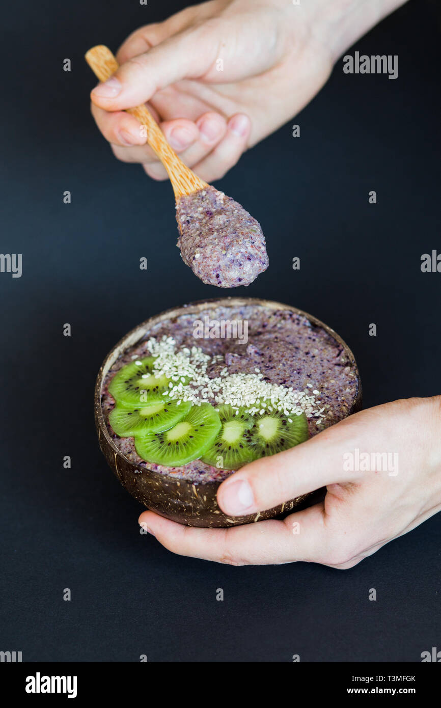 Healthy smoothie with fruits, plate made from coconut shell and wood ...