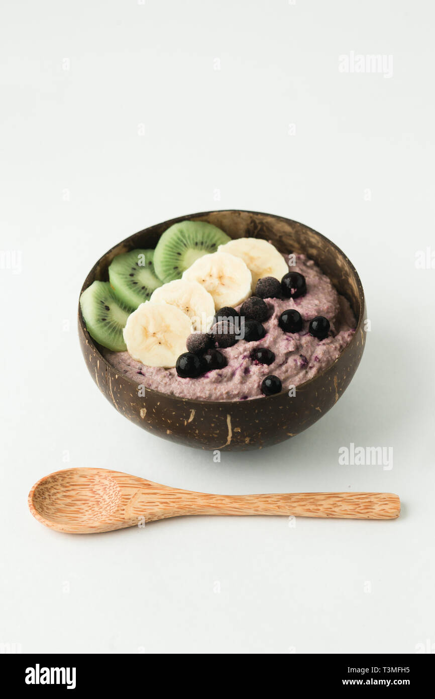 Healthy smoothie with fruits, plate made from coconut shell and wood ...