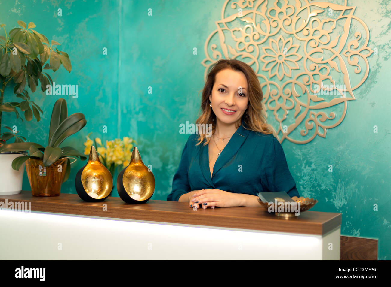 Beautiful woman at reception desk in yoga and wellness center Stock ...