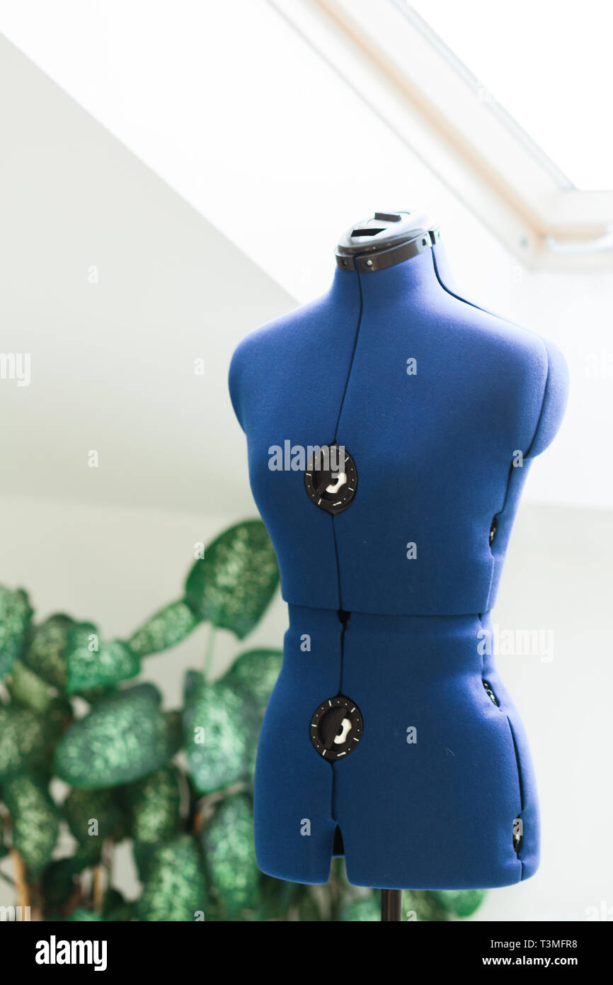 sewing blue mannequin with main marks for removing of measures standing ...